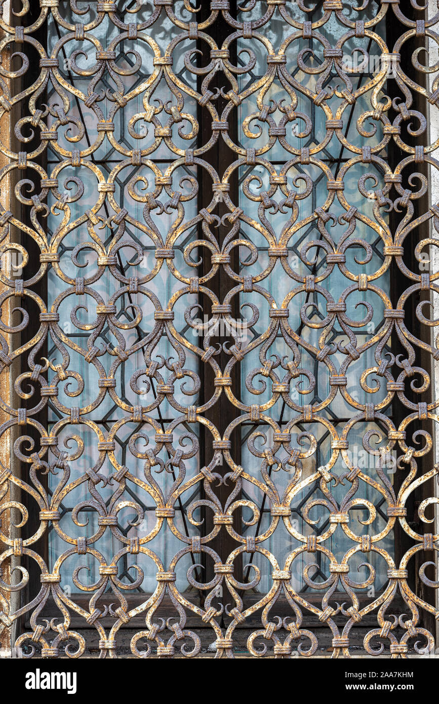 Venice, detail of an ancient window with grating in wrought iron ...