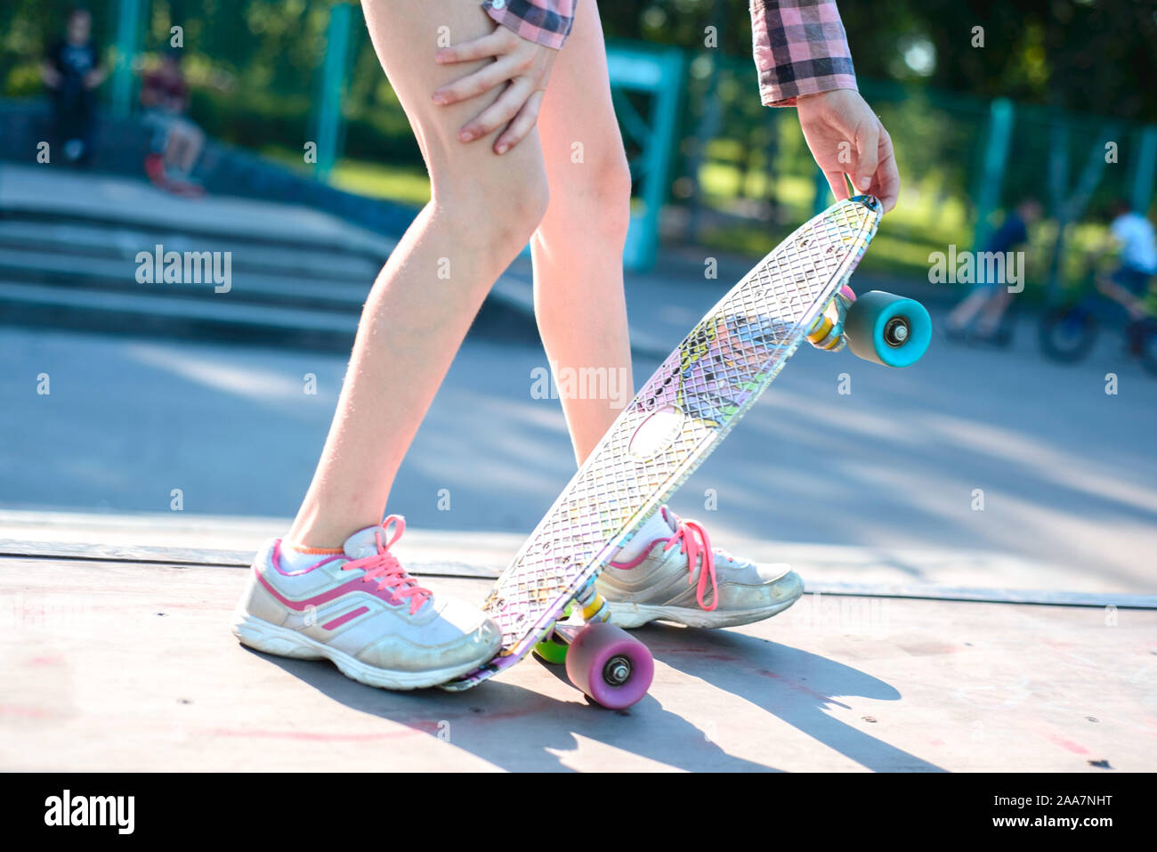 Skater female rides on skateboard at skate park ramp. Young woman ...
