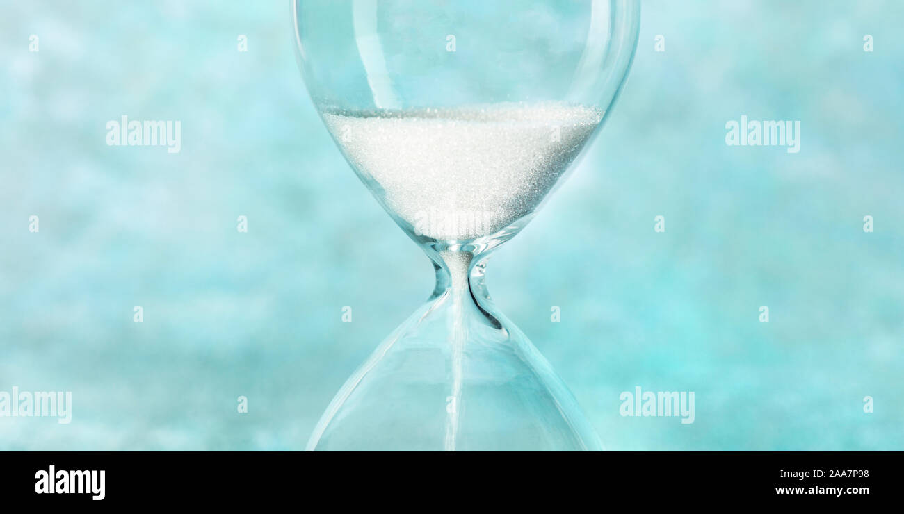 Hourglass panorama. Time is running out concept. A close-up of a sand ...