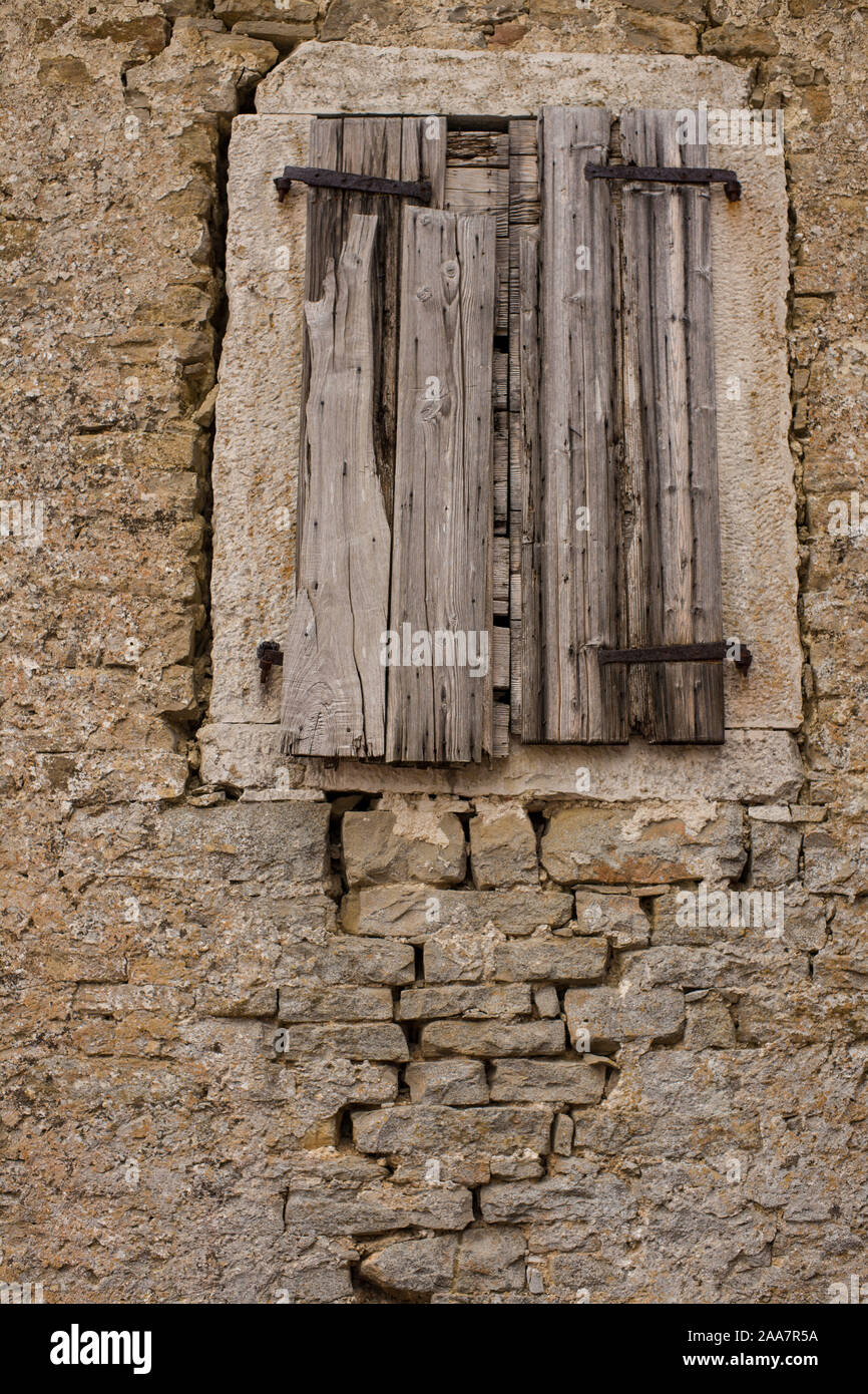 Ancient window with closed shutters in aged stone wall Stock Photo - Alamy