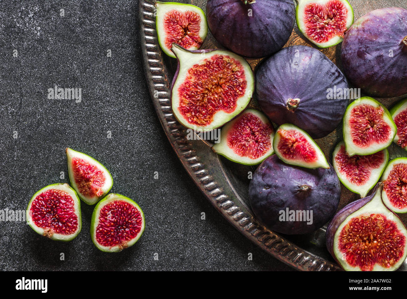 Fresh fig fruits. Halved and whole ripe blue figs, top view Stock Photo ...