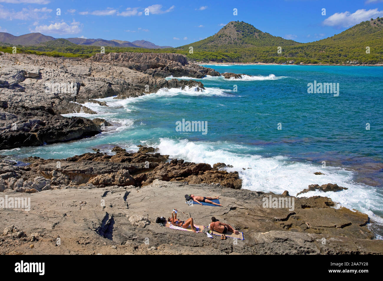 People at the rocky coast at Cala Agulla, Cala Ratjada, Mallorca ...