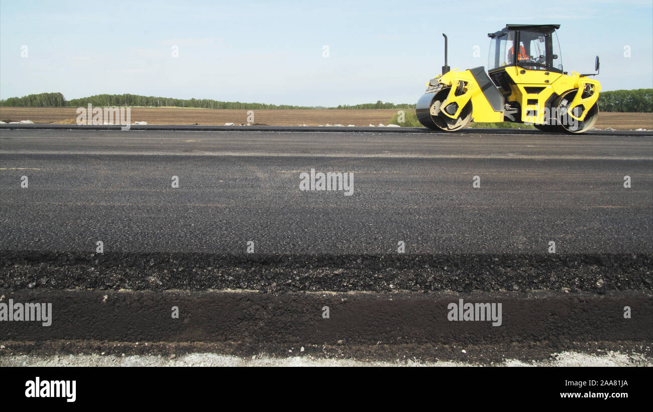 Road construction Steam rink rolls new asphalt on the road Stock Photo ...