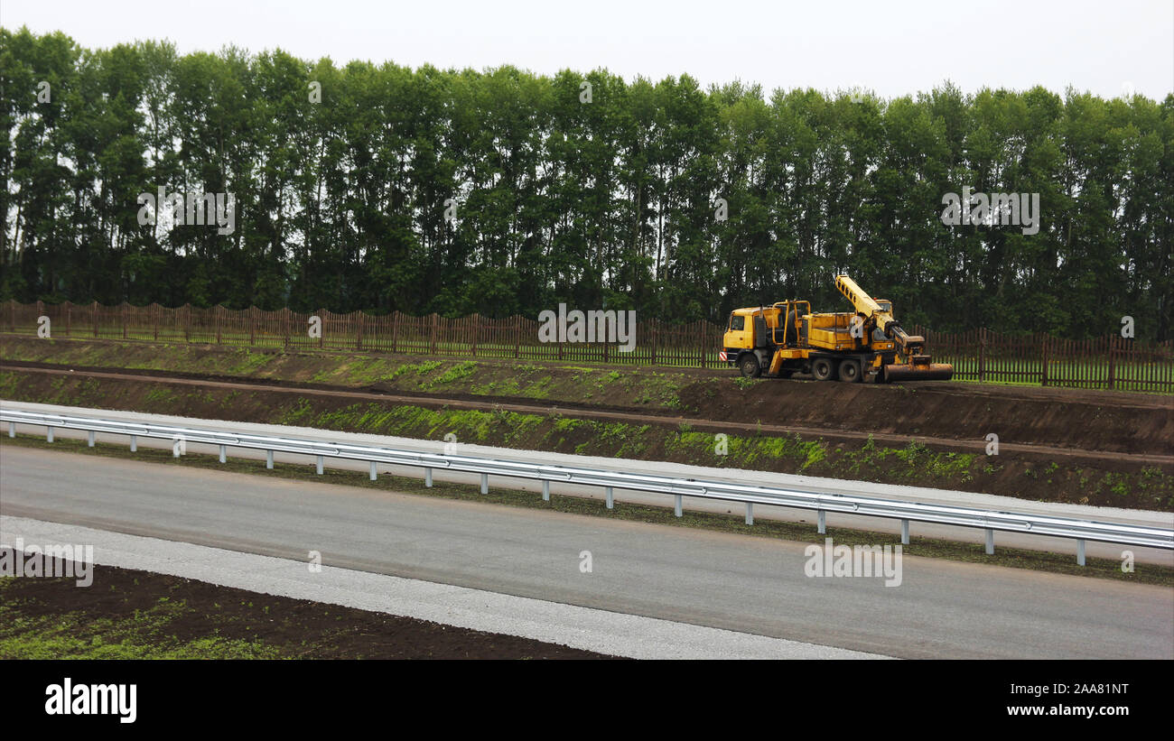 Road construction, Excavator Truck Levels Ground Near New Road Stock ...