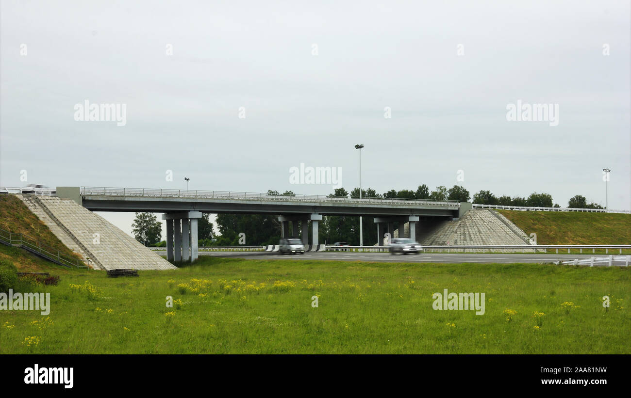 cars driving on the highway. Overpass bridge crosses the road Stock ...
