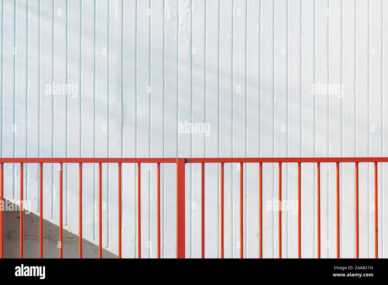 Red steel bar fence and white stripped wall, abstract urban minimal ...