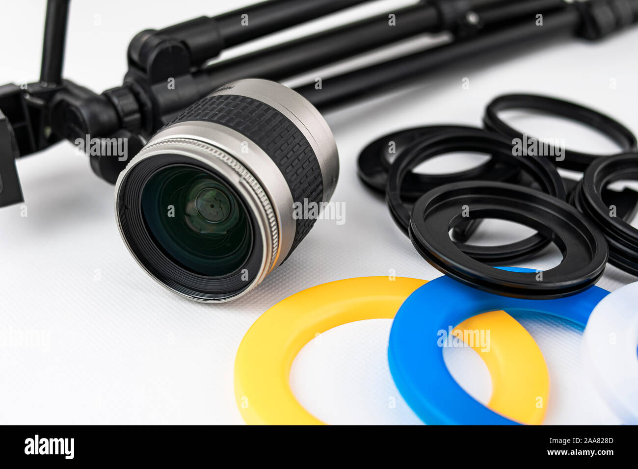 Close-up of the shutter of a photo camera lens, with small tripod and ...