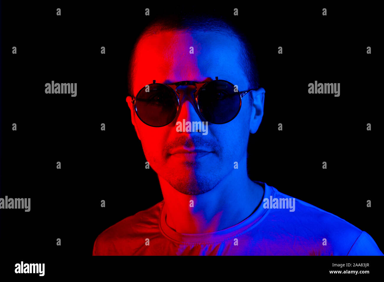 Portrait of man with blue and red color lights and glasses Stock Photo ...
