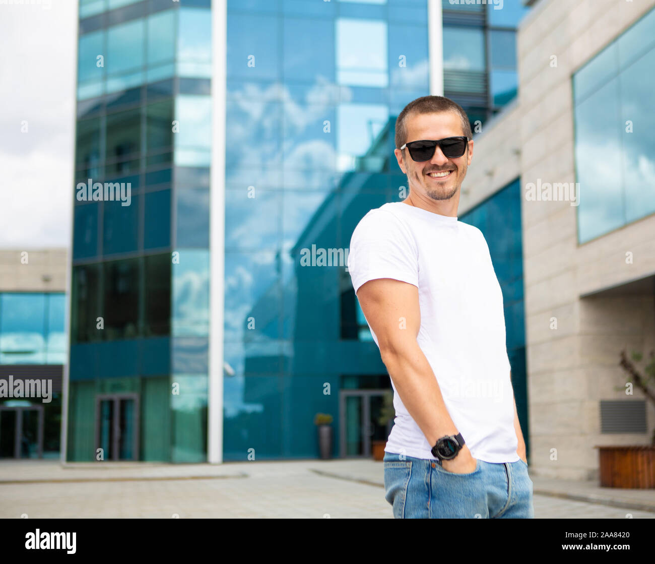 Man standing outdoor near office building and smiling Stock Photo - Alamy