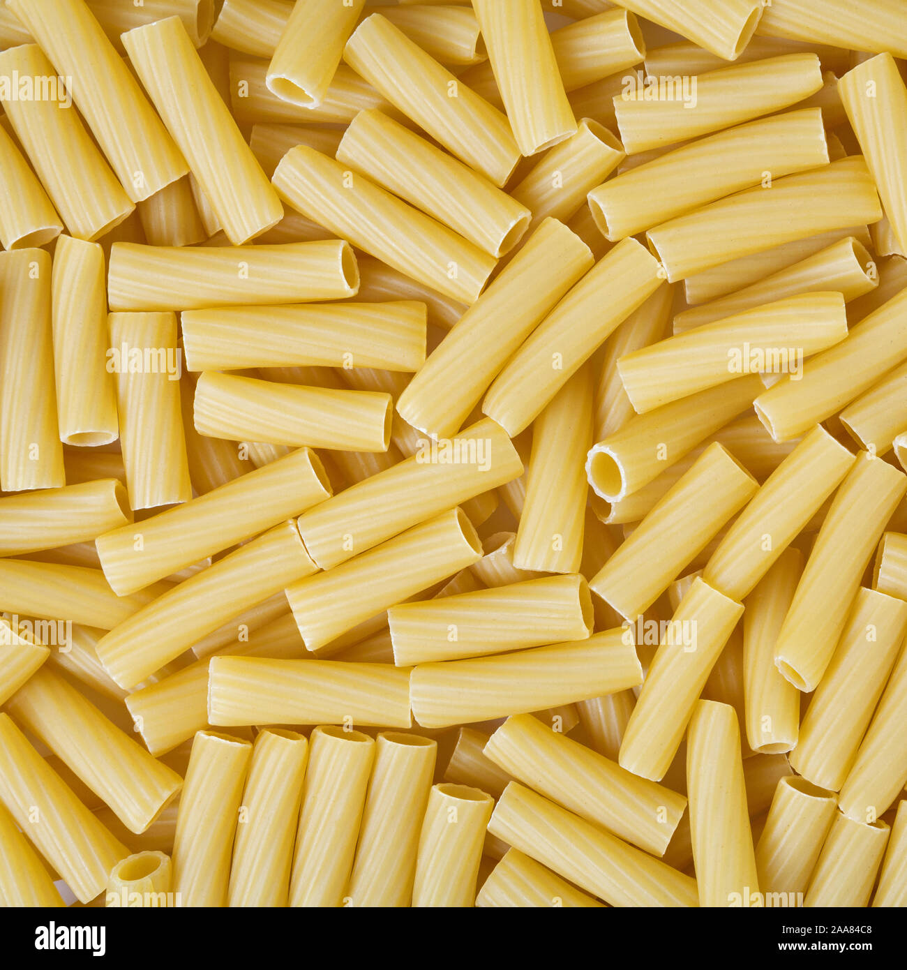 Uncooked tortiglioni pasta background Stock Photo - Alamy