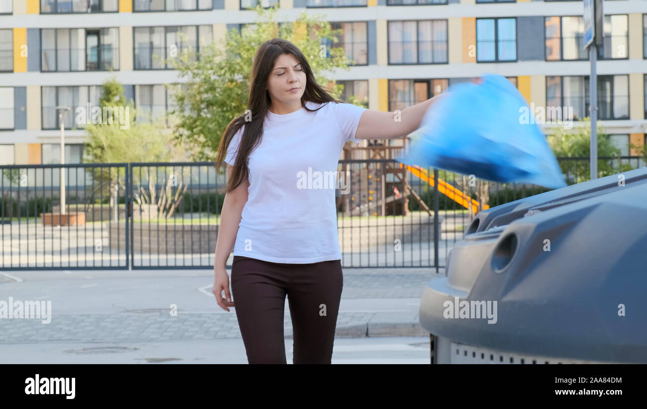 Woman dropping bin hi-res stock photography and images - Alamy
