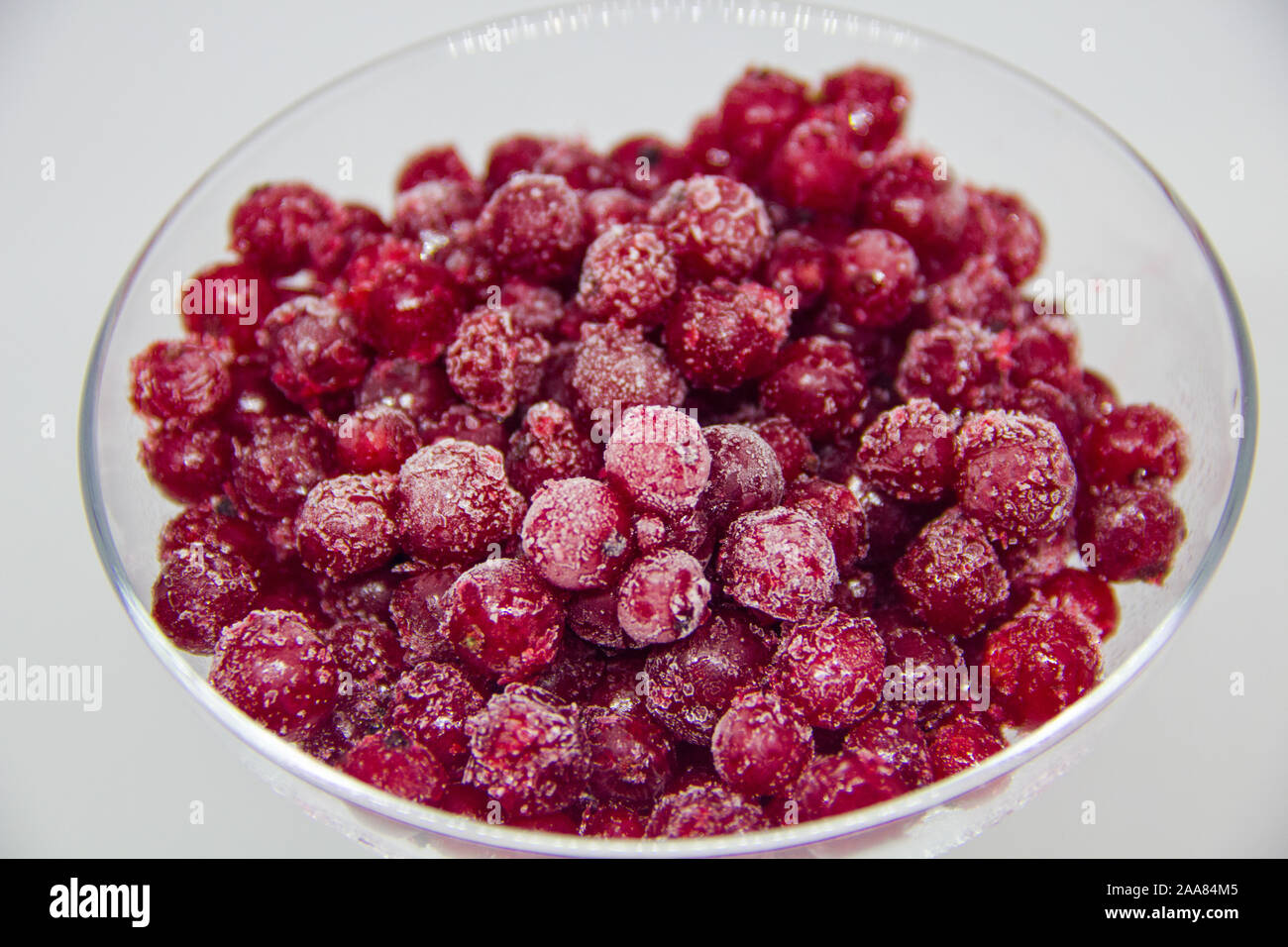 frozen red currants in a glass plate on a white background Stock Photo ...