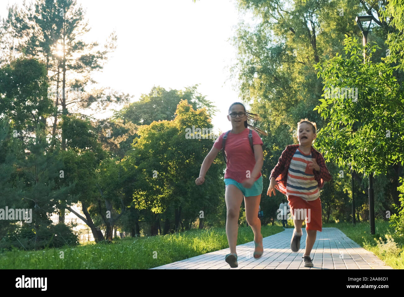 Children and education, sister and brother, schoolchildren run along ...