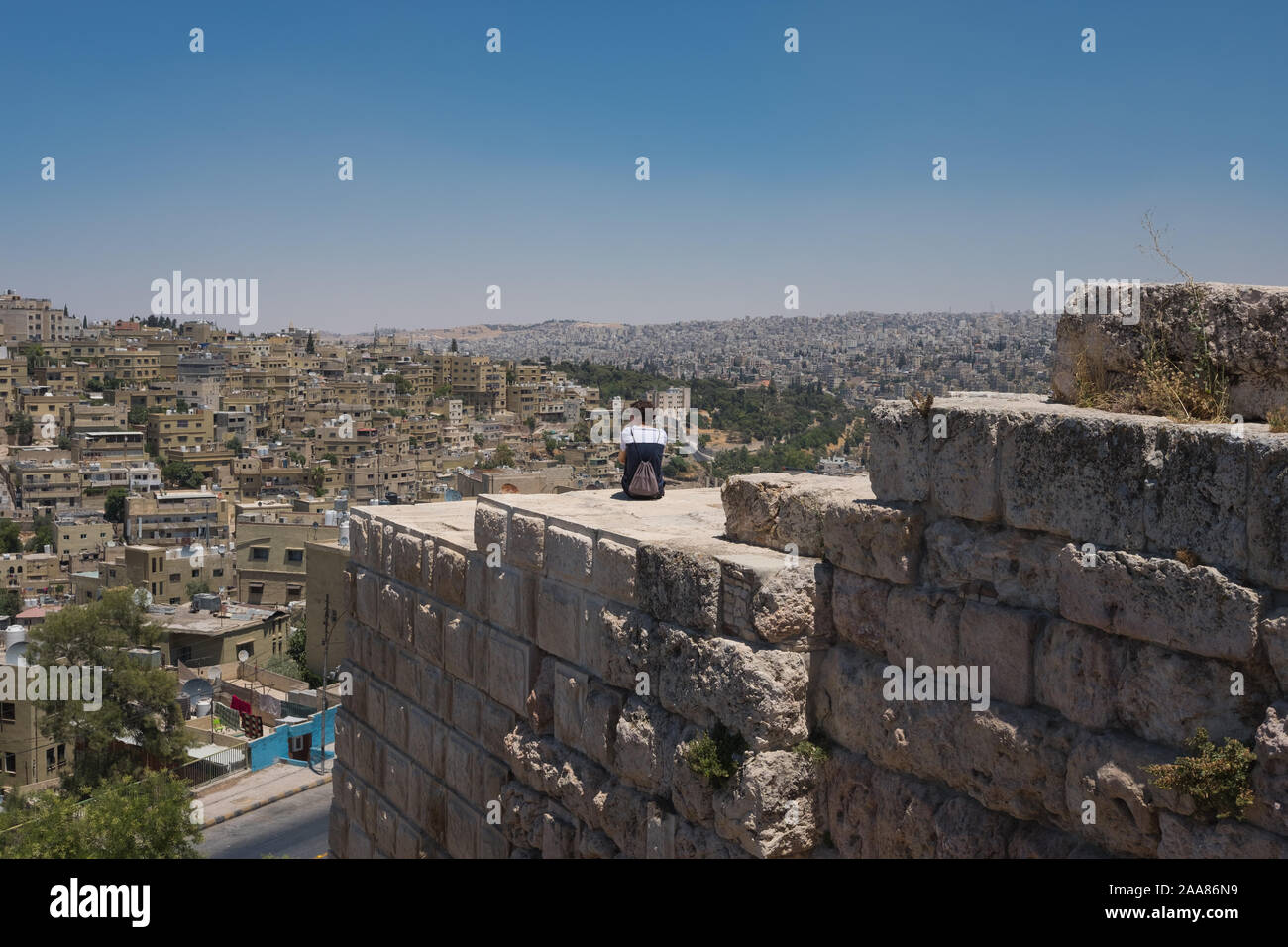 Tourist sitting on the Citadel wall, Amman, Jordan Stock Photo - Alamy