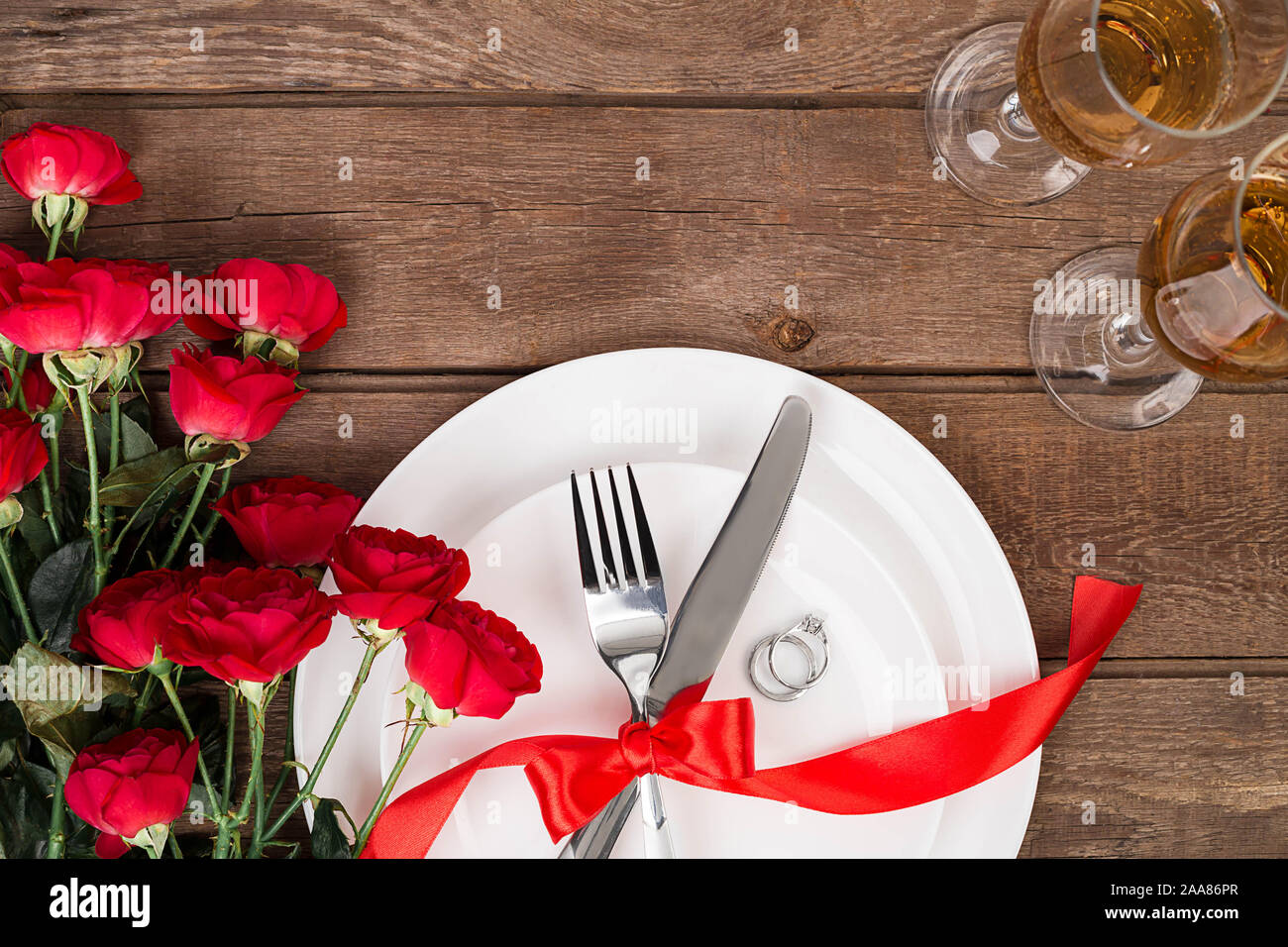 Valentines Day Dinner Table Setting With Red Ribbon Roses Knife And
