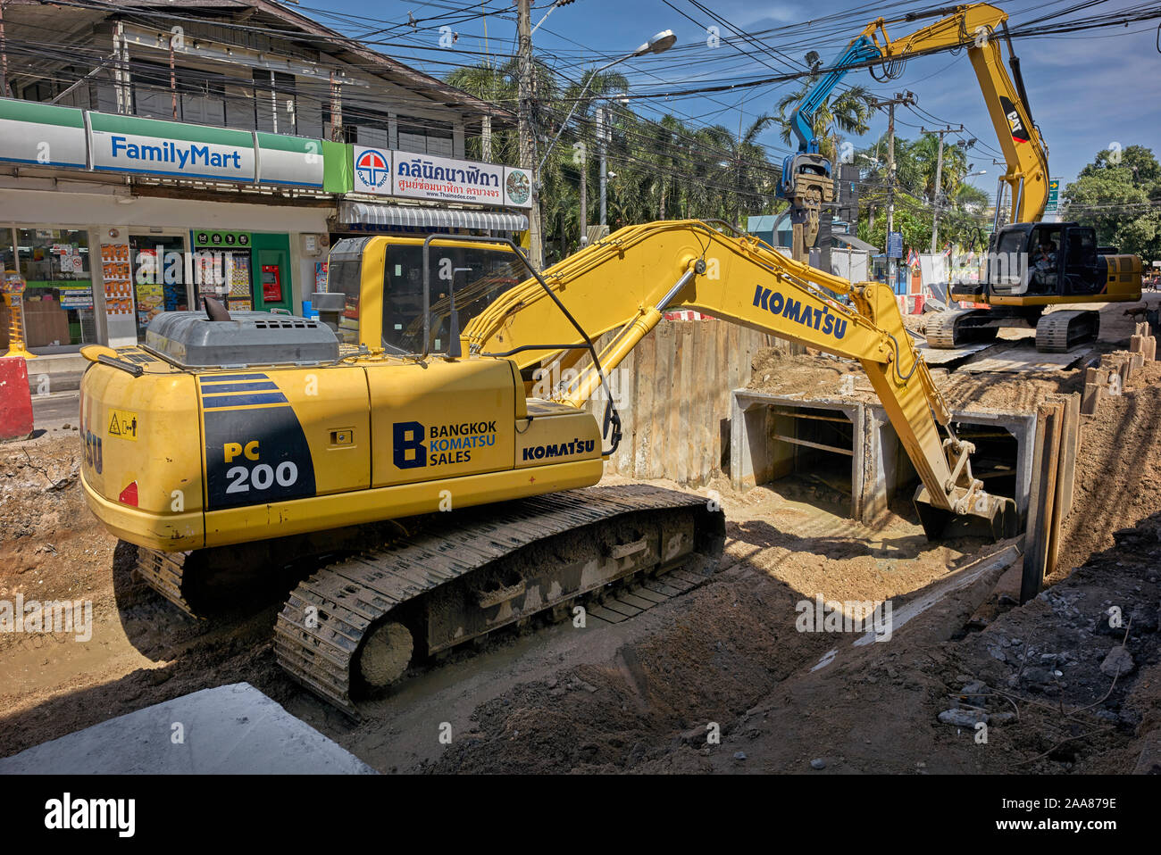 Drain installation using backhoe heavy plant digging machinery. Pattaya ...