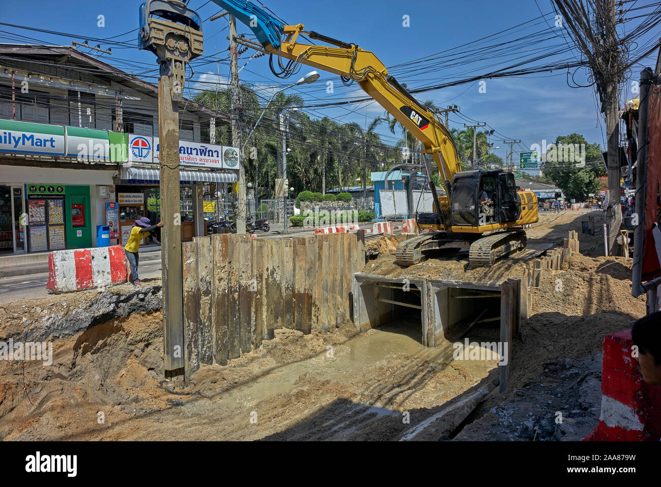 Drain installation using backhoe heavy plant digging machinery. Pattaya ...