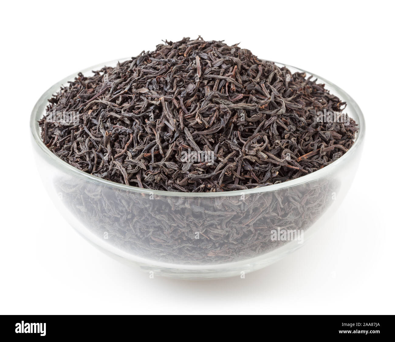 Dry black tea in glass bowl isolated on white background with clipping ...
