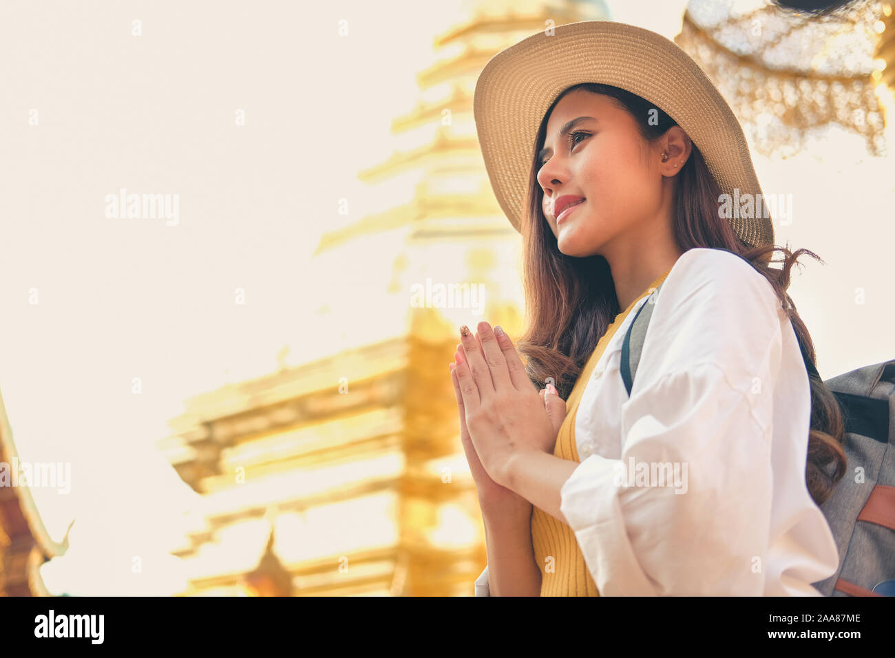 young asian woman traveler tourist praying at buddhist temple. journey ...