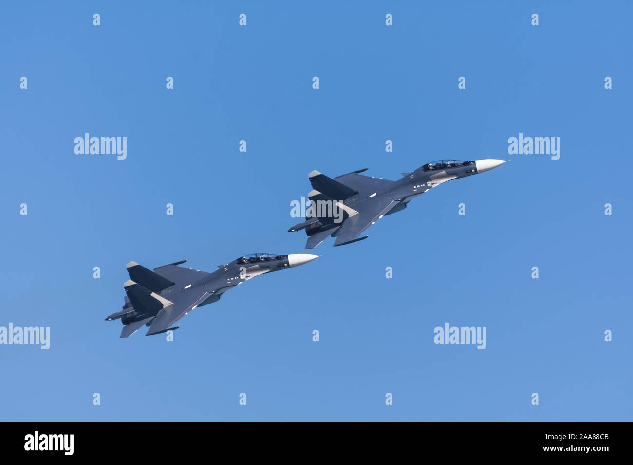 Pair of fighters flying in tight formation Stock Photo - Alamy