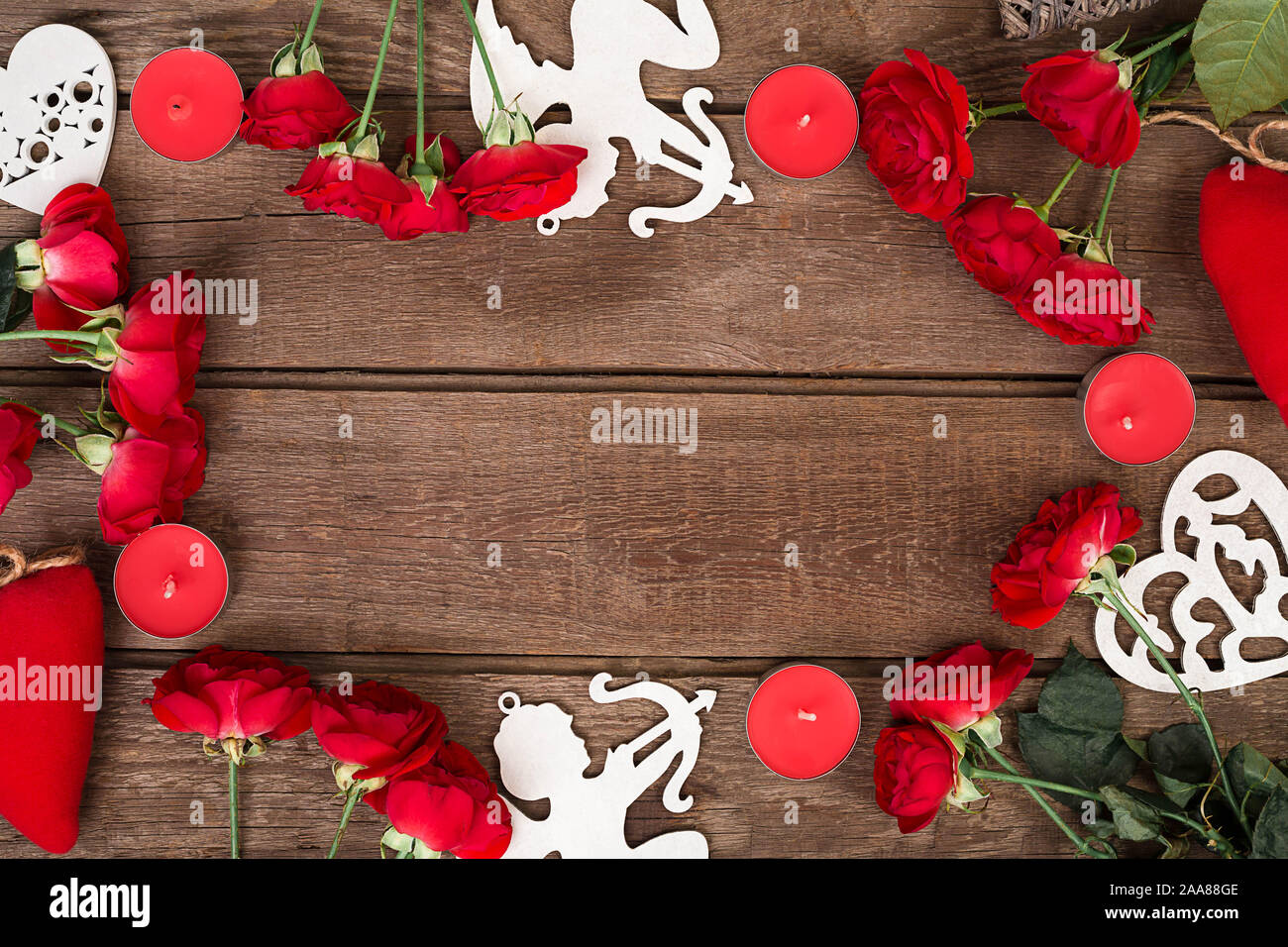 Red roses, candles and hearts over wood with copy space. Valentines day ...
