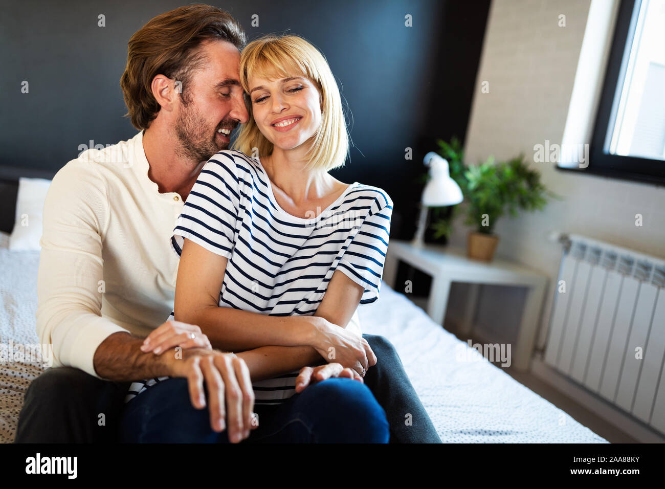 Couple in love hugging and bonding with true emotions at home Stock ...