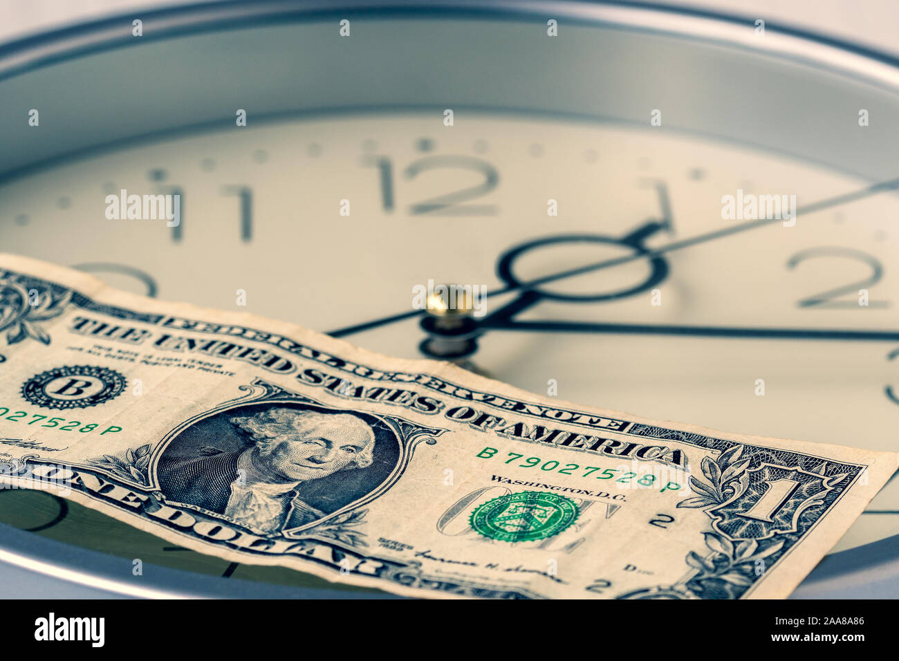 Time is money. Wall clock and banknote of USD Stock Photo - Alamy