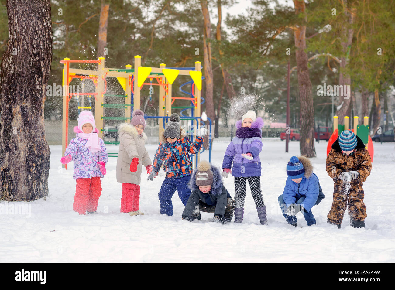 A group of children are playing and having fun on a winter playground ...