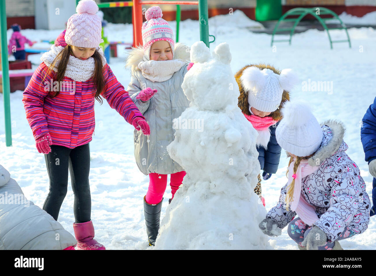Children building a snowman hi-res stock photography and images - Alamy