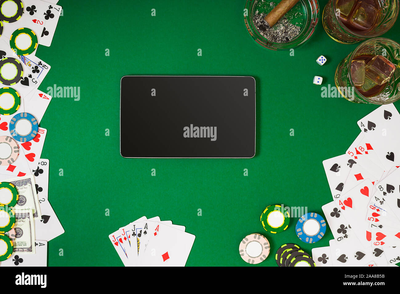Set to playing poker with cards and chips on green background. Top view ...