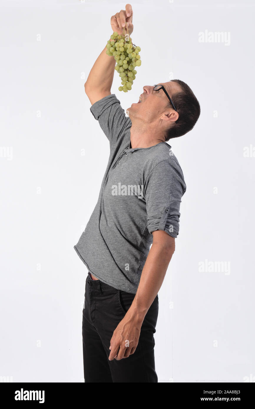man with grape on white background Stock Photo - Alamy