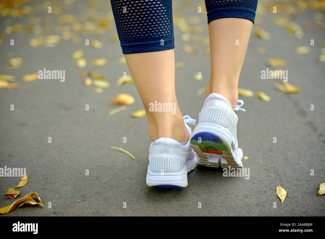 girl athlete in training uniform runs on the track Stock Photo - Alamy