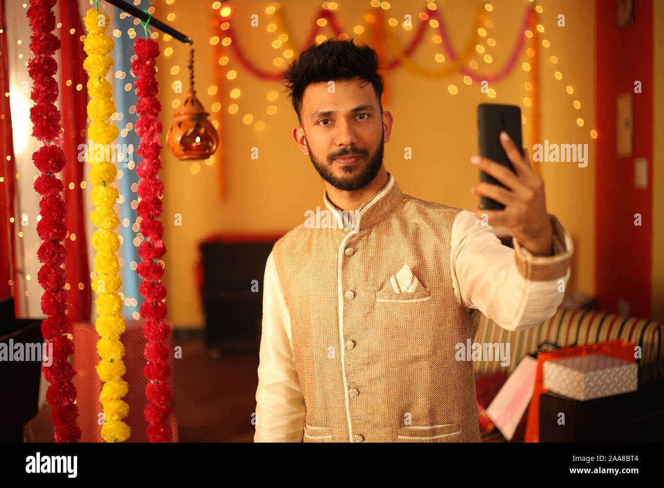 Indian man is Celebrating Diwali. Isolated on decorative background ...