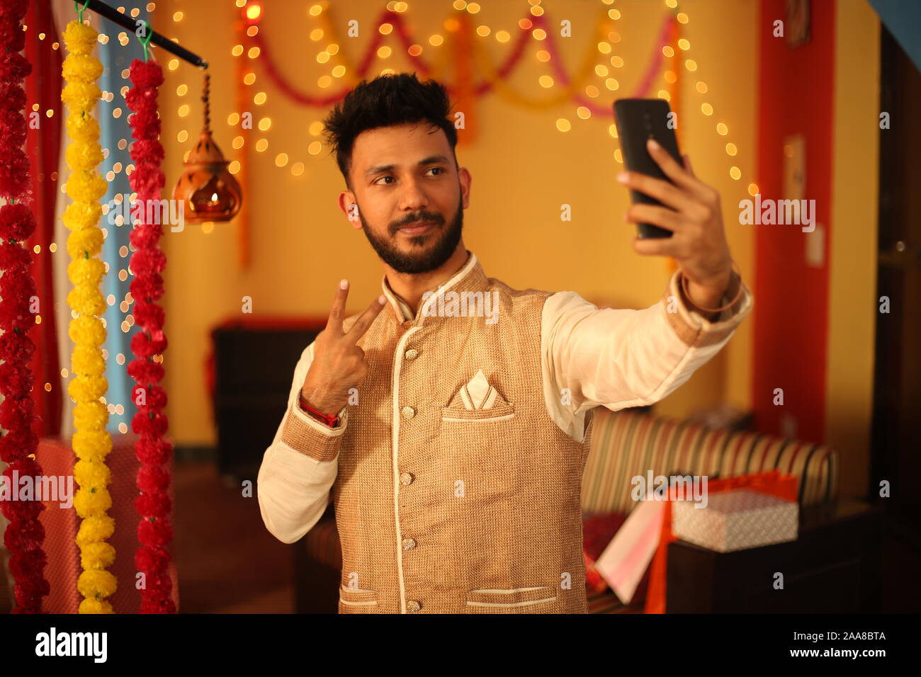 Indian man is Celebrating Diwali. Isolated on decorative background ...