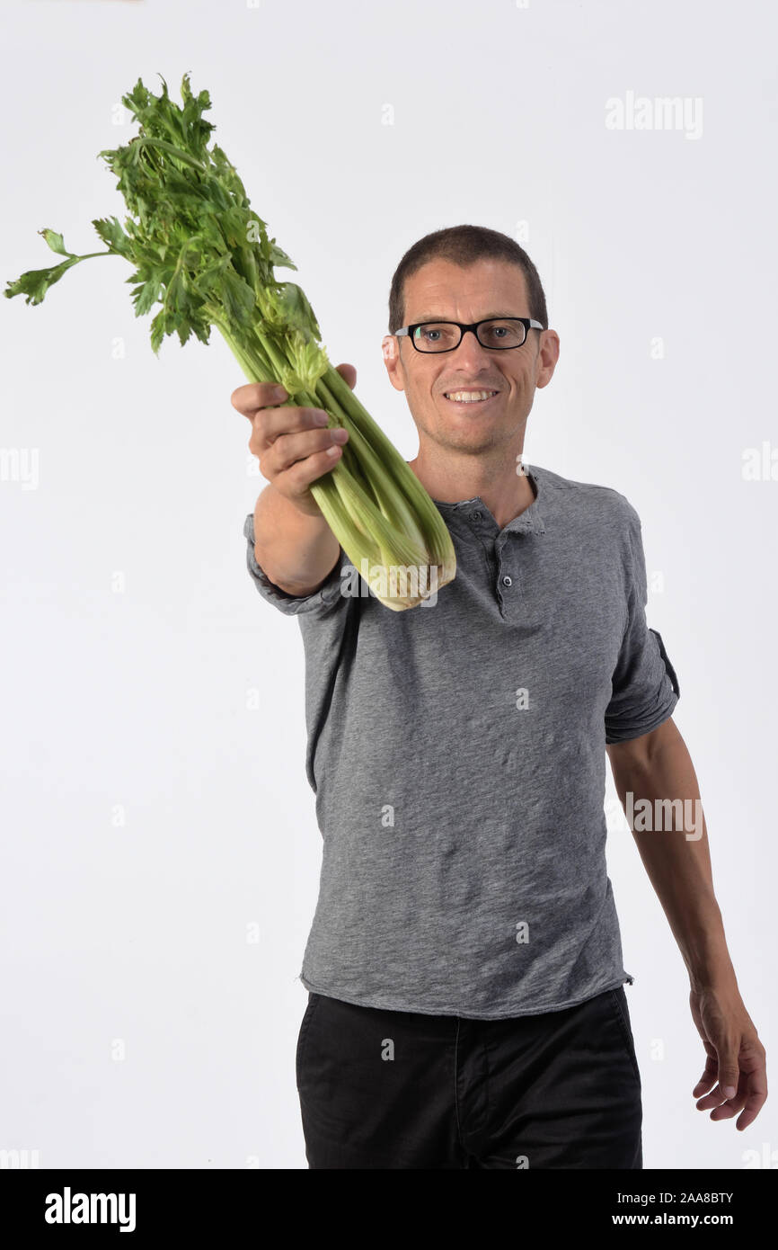 portrait of a man with celery on white background Stock Photo - Alamy