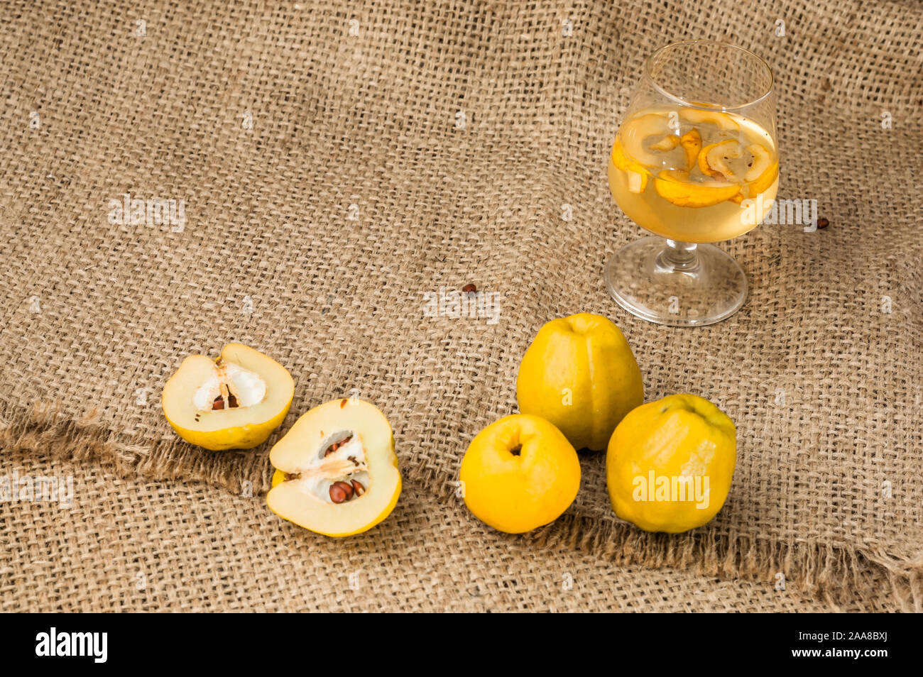 Glass of wine with quince fruits, homemade alcohol tincture on rustic ...