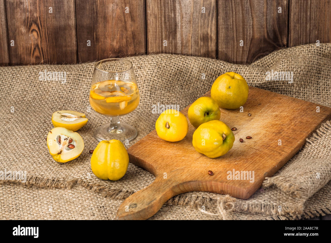 Quince fruits tincture in a glass on a canvas background Stock Photo ...