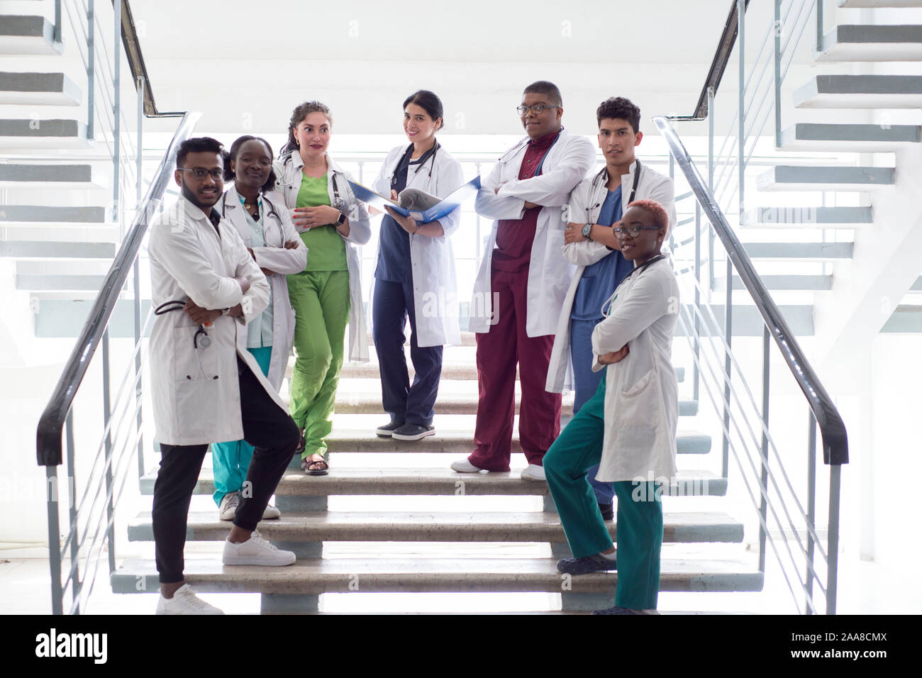 medical students, doctors, mixed race. A team of young people in white ...