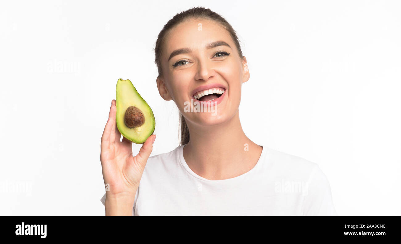 Positive Girl Standing Holding Avocado Half, Studio Shot, Panorama ...
