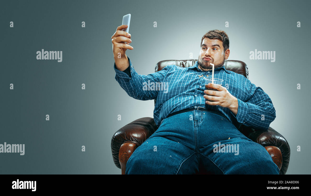 Fat man on chair hi-res stock photography and images - Alamy