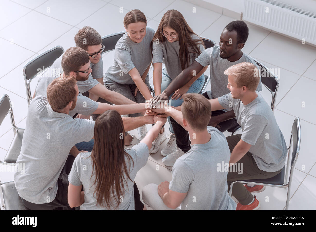 young business people making a tower out of their hands Stock Photo - Alamy