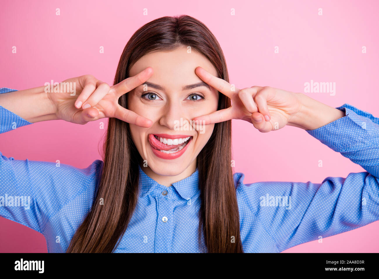 Close up photo of amazing lady showing v-sign symbols near eyes licking ...