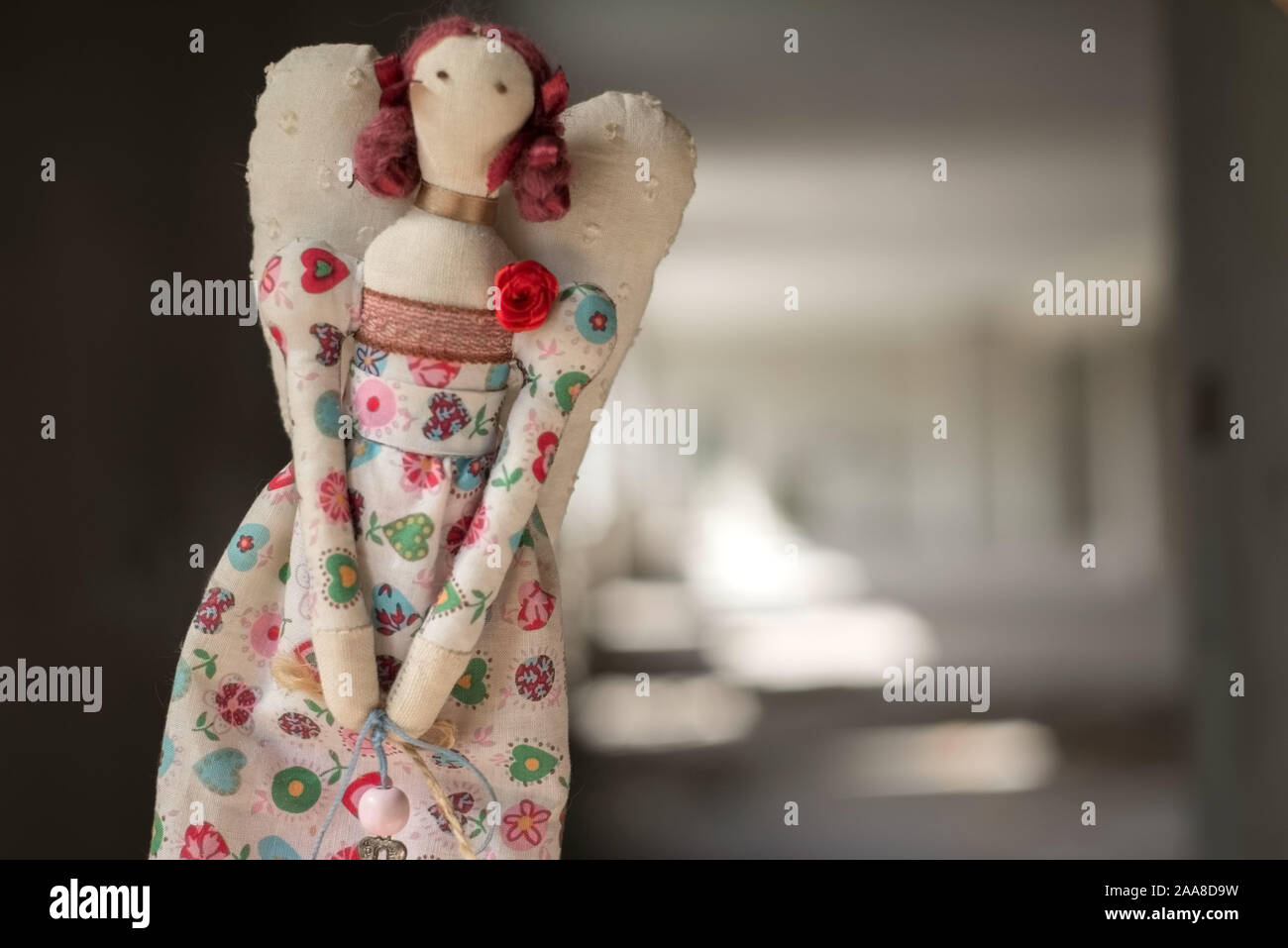 Portrait of a colorful voodoo doll. Against the background of light ...