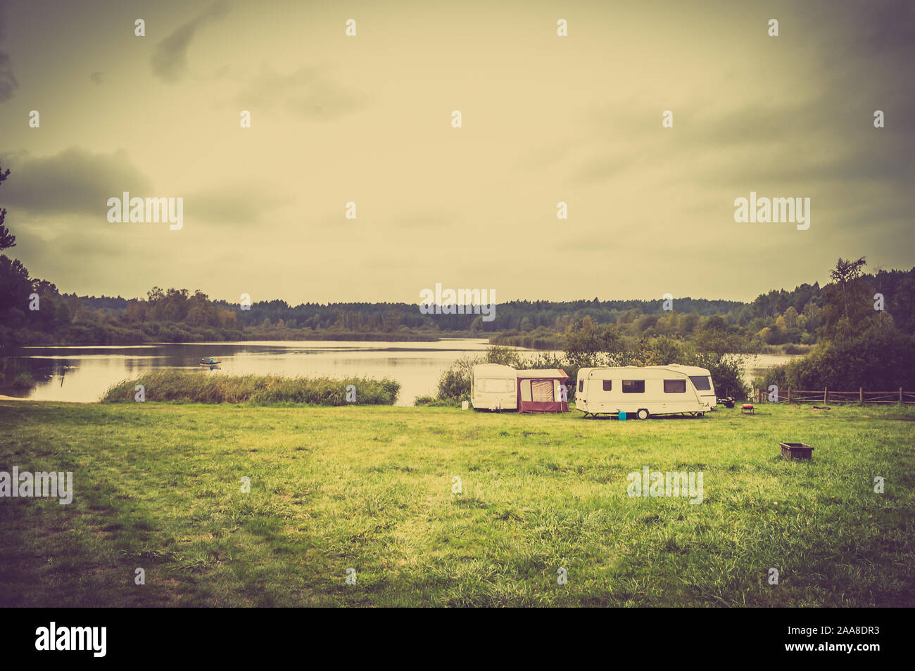 Caravan camping on the lake in the summer vacation. Camp with camper ...