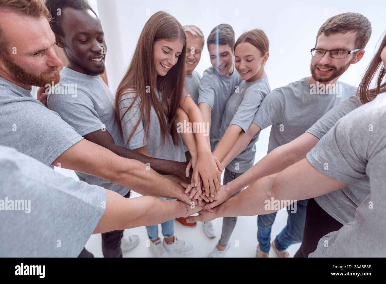 close up. a group of young people showing their unity Stock Photo - Alamy