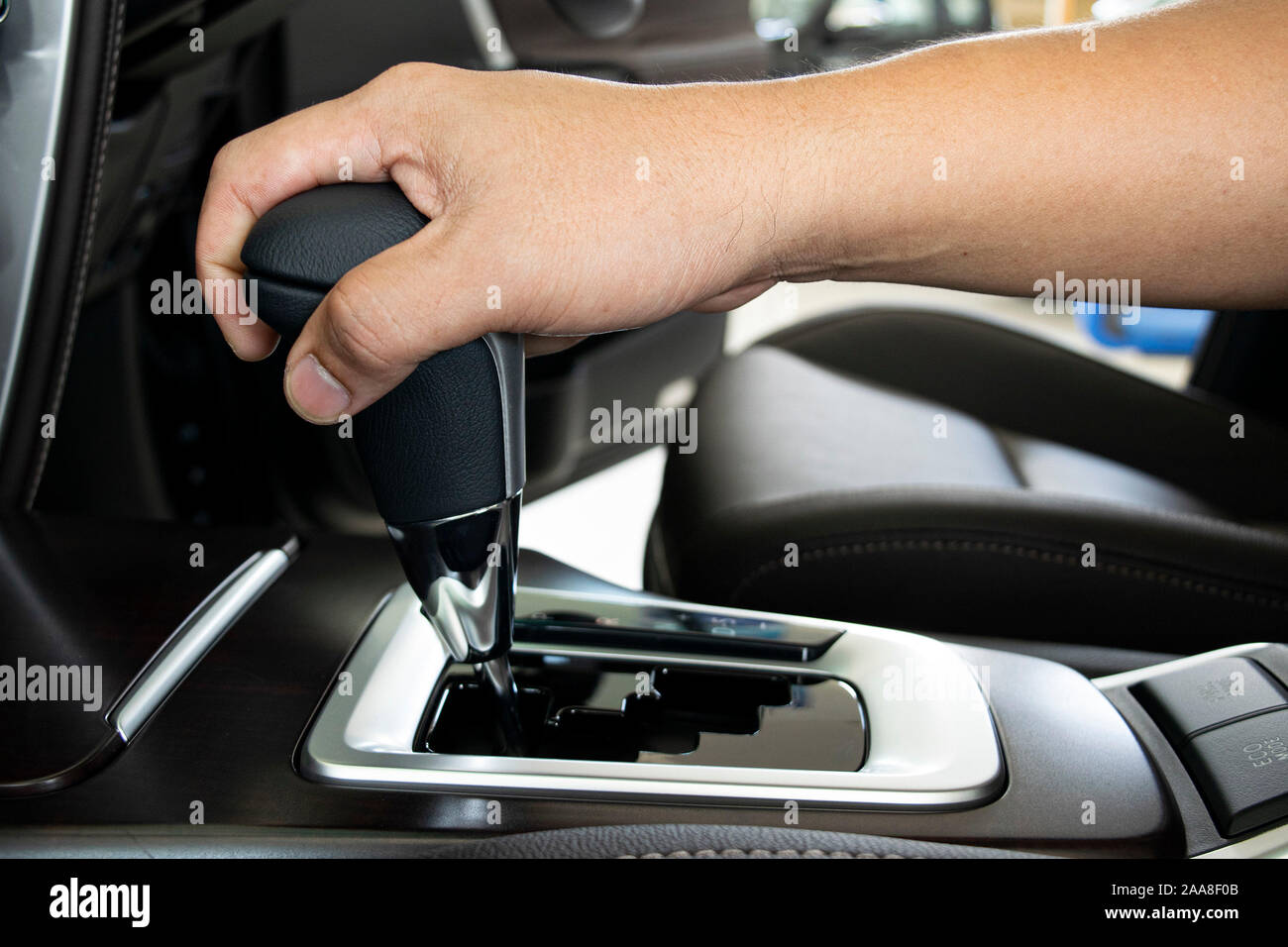 Hand grab on automatic gear shift in car Stock Photo - Alamy