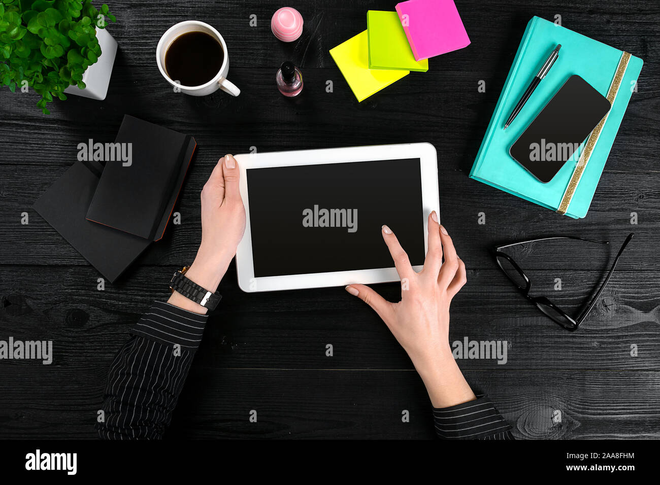 Hand use tablet on desk table top view. Copy space. Flat lay. Black ...