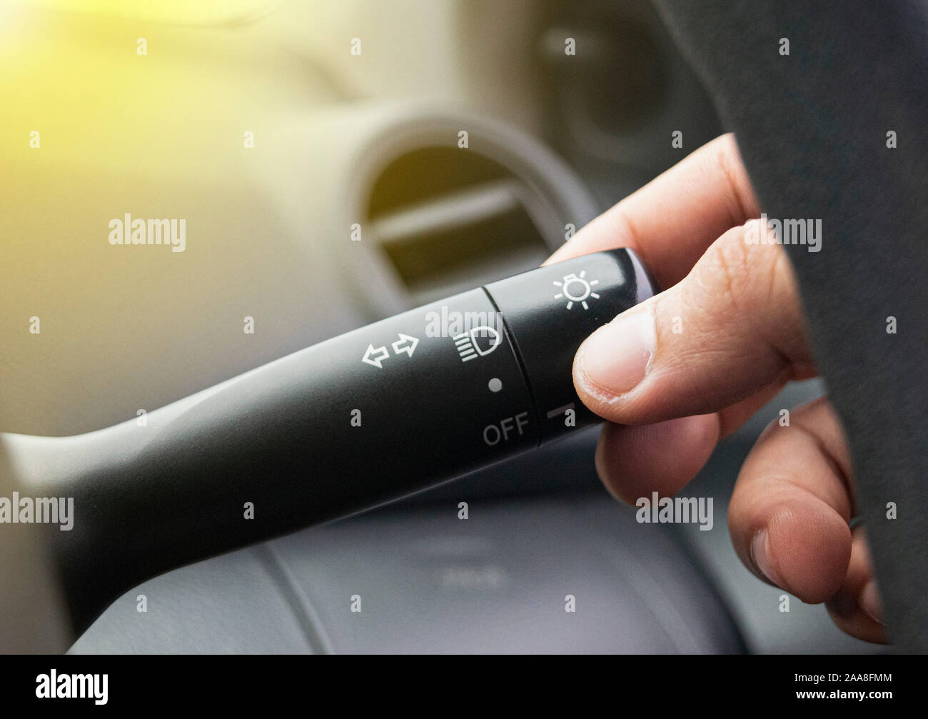 Hand adjusting car headlight control switch Stock Photo - Alamy
