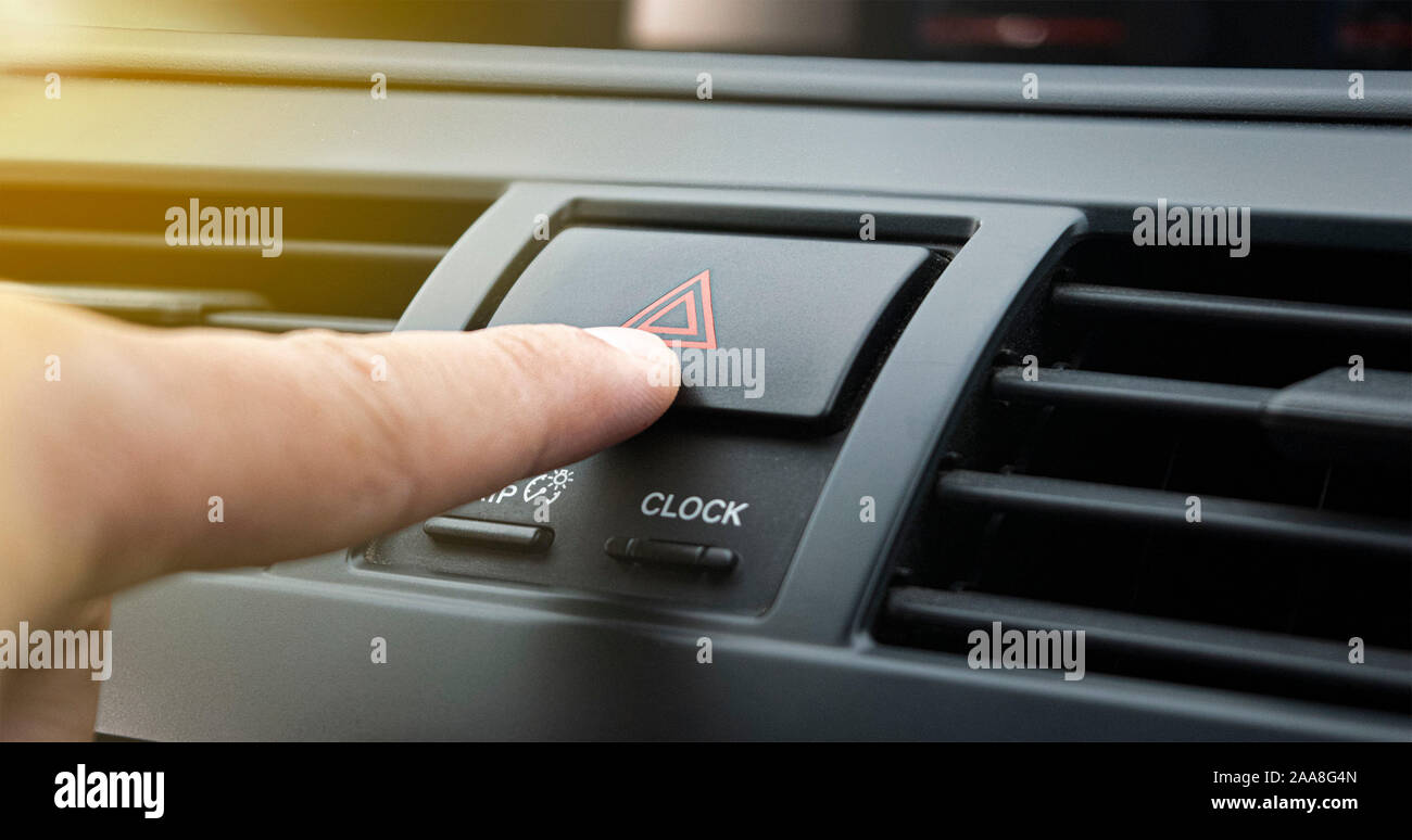 Finger hitting Emergency button in the car .hazard lights Stock Photo ...