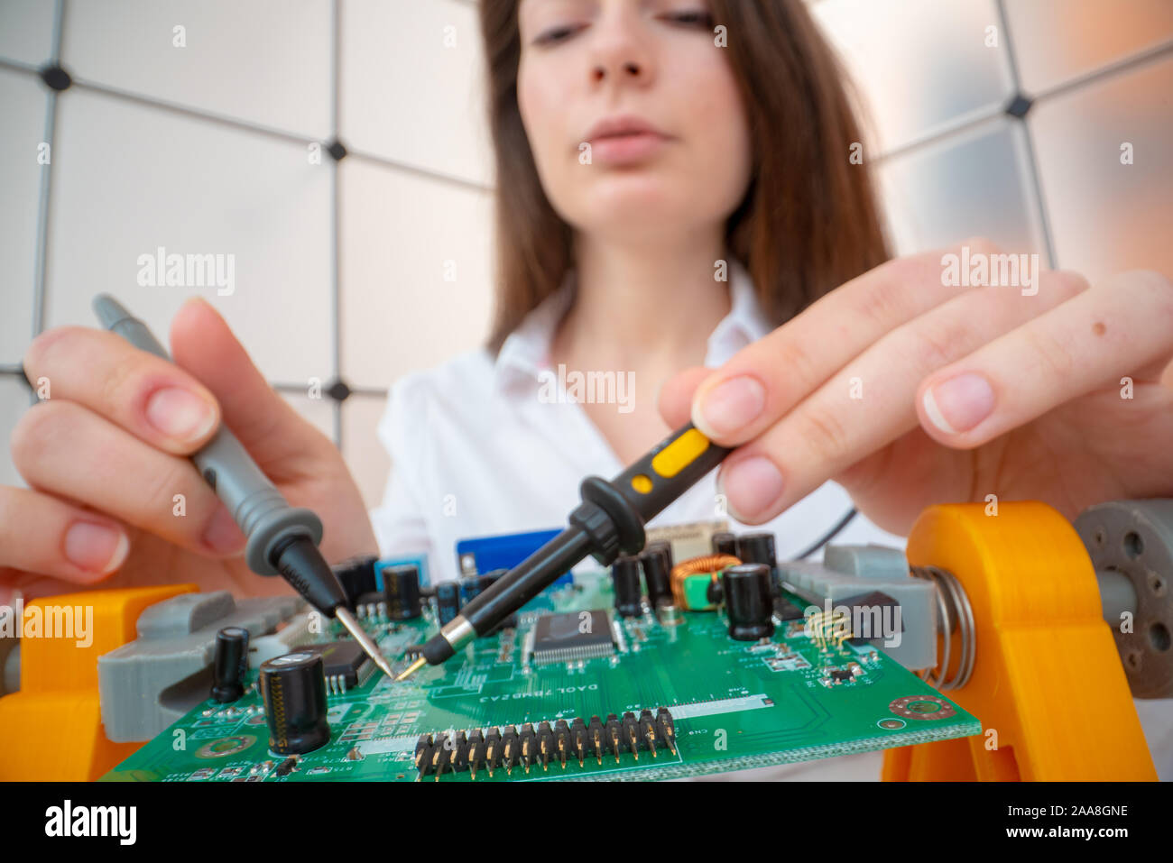 Young woman with measuring devices in the electronics engineer ...